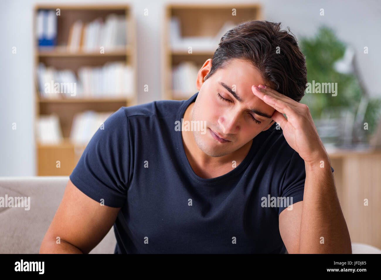 Young handsome man suffering from pain Stock Photo - Alamy