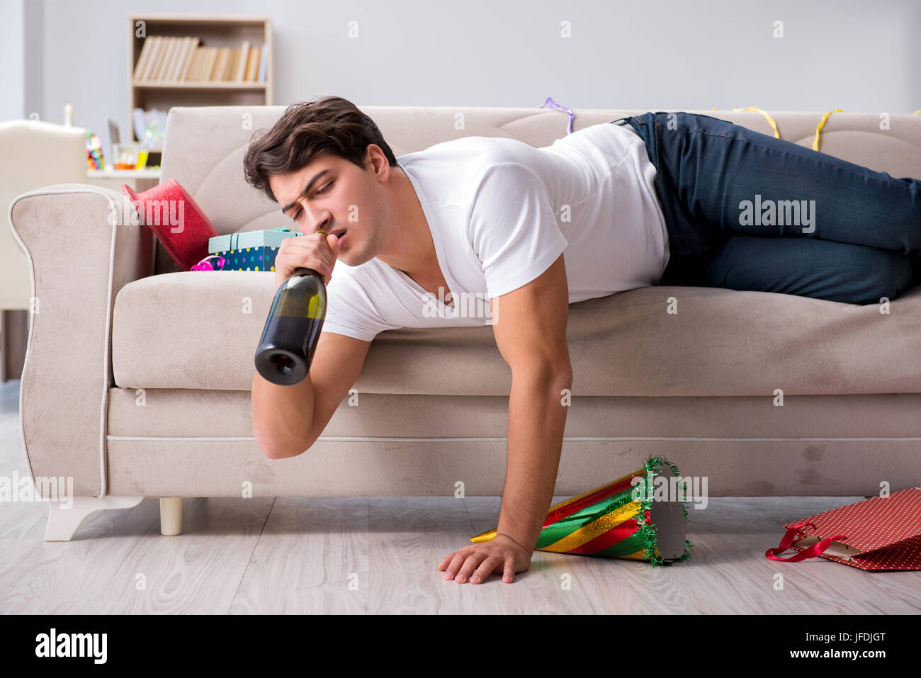 Man at home after heavy partying Stock Photo - Alamy