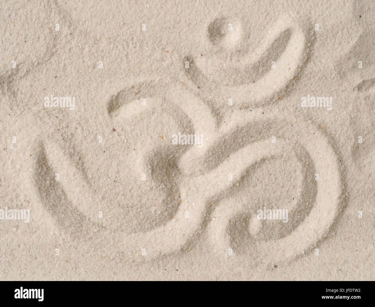 Om symbol written in sand, view from above, have a break or meditation ...