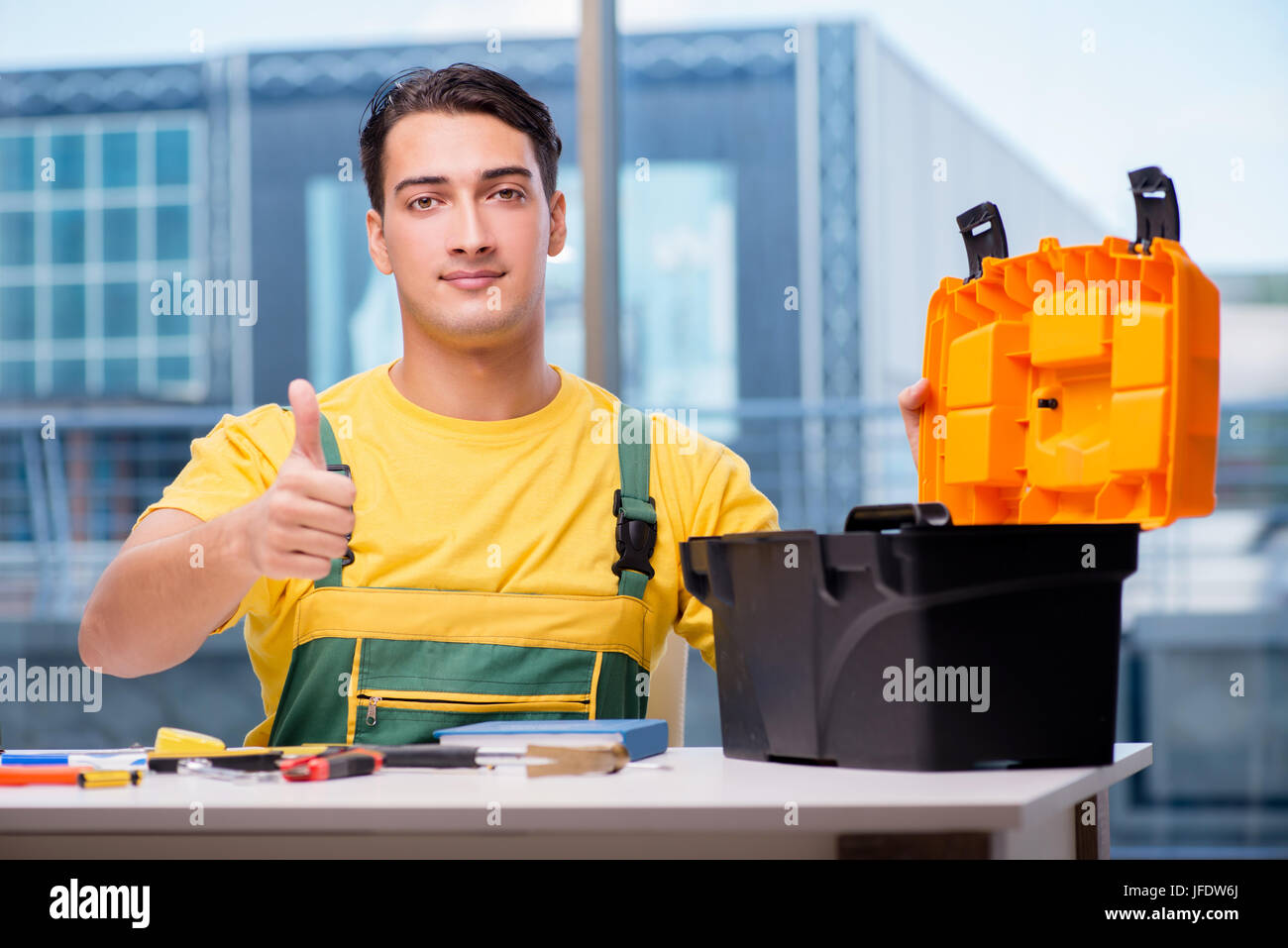 Construction worker sitting at the desk Stock Photo - Alamy