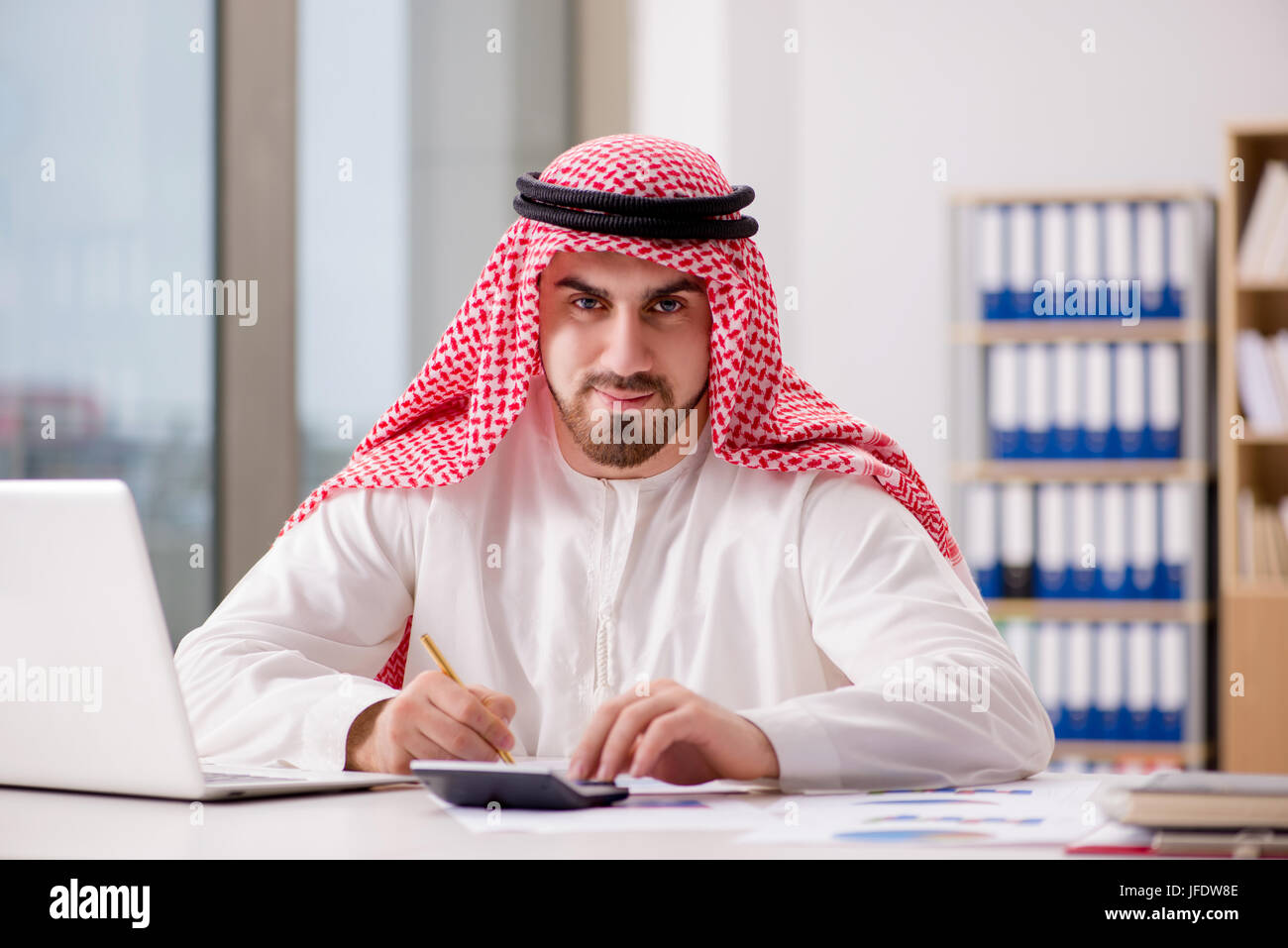 Arab businessman working on laptop computer Stock Photo - Alamy