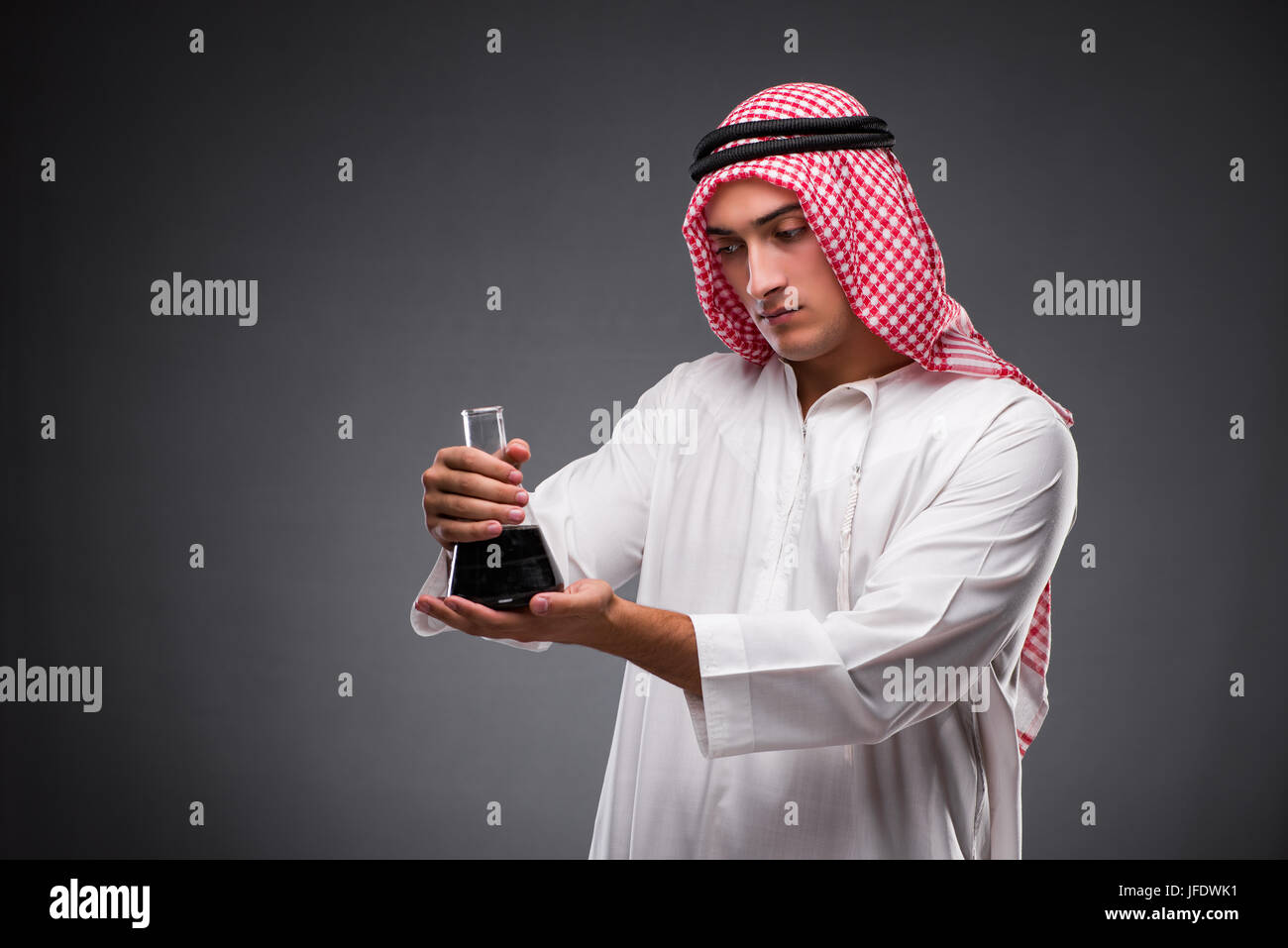 Arab with oil on gray background Stock Photo - Alamy