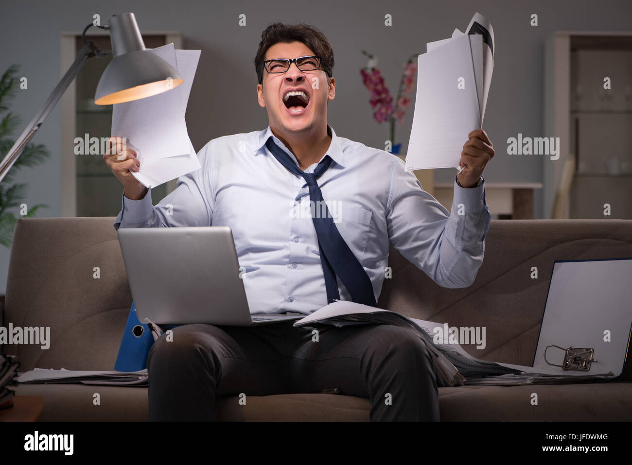 Businessman workaholic working late at home Stock Photo - Alamy