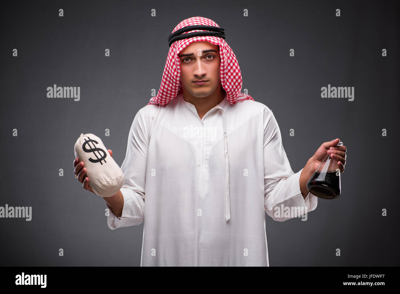 Arab with oil on gray background Stock Photo - Alamy