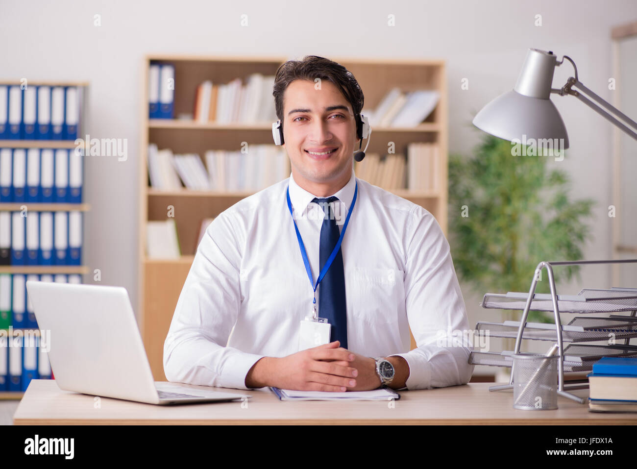 Handsome customer service clerk with headset Stock Photo - Alamy