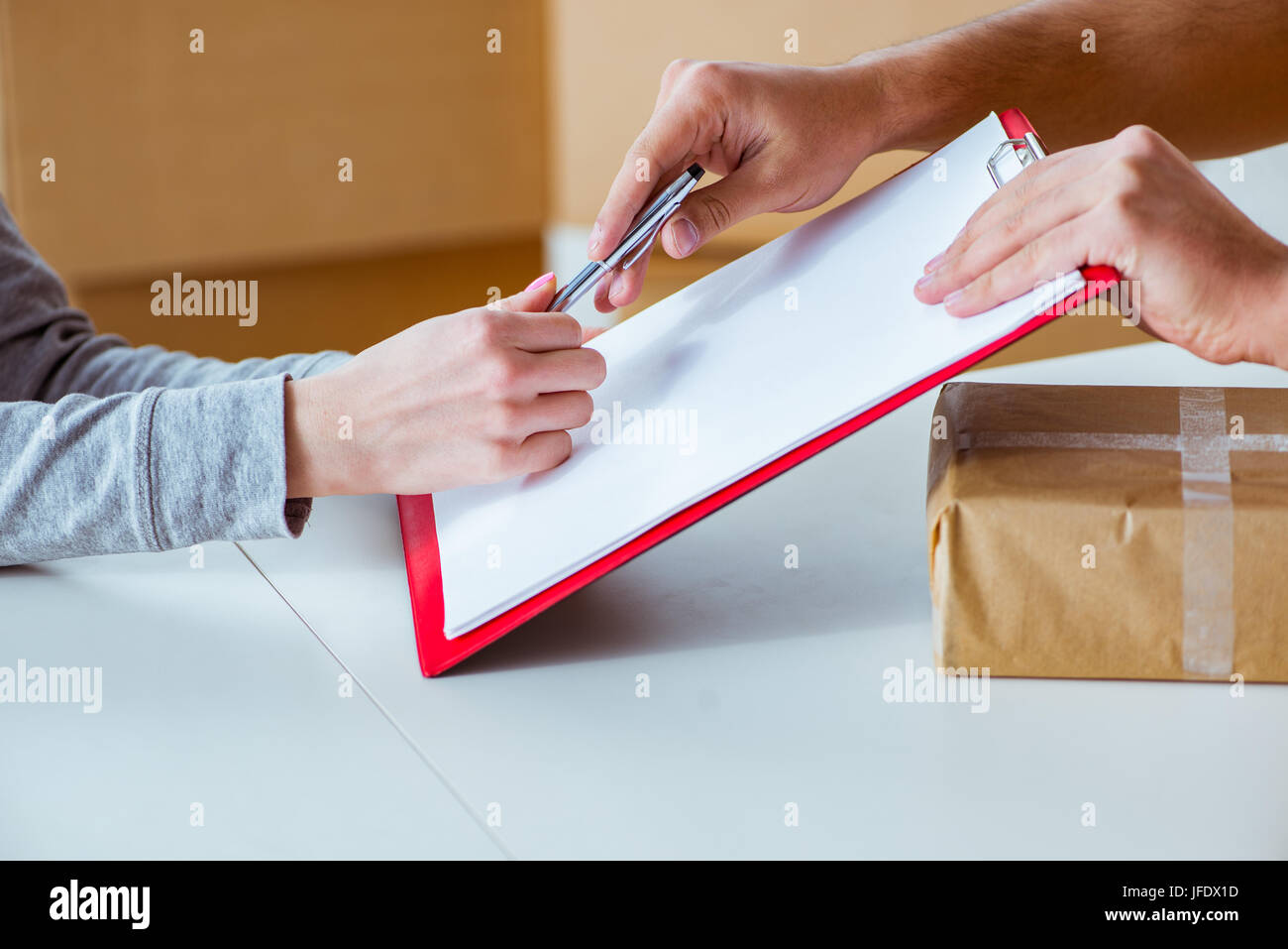 Delivery man delivering parcel box Stock Photo - Alamy