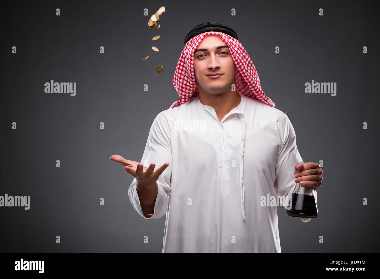 Arab with oil on gray background Stock Photo - Alamy