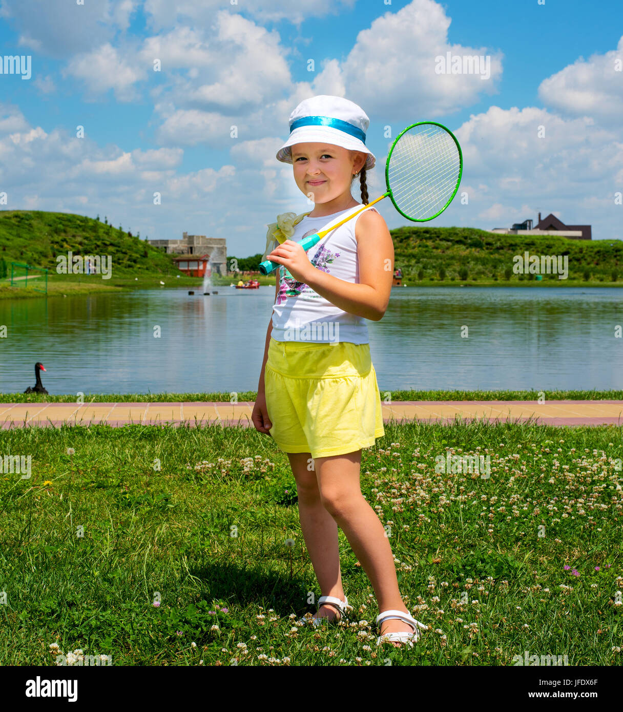 girl on grass with a racket Stock Photo - Alamy