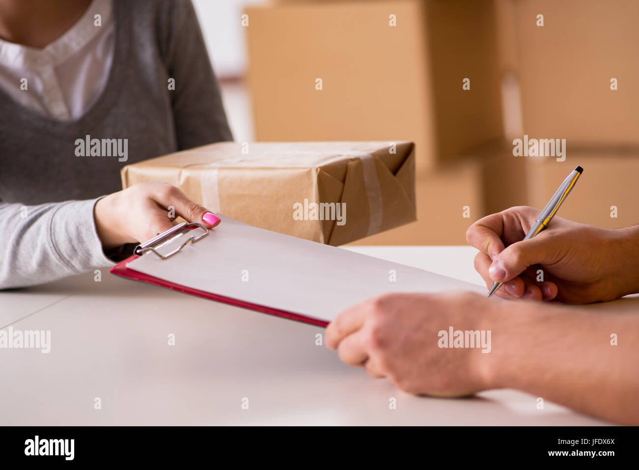 Delivery man delivering parcel box Stock Photo - Alamy