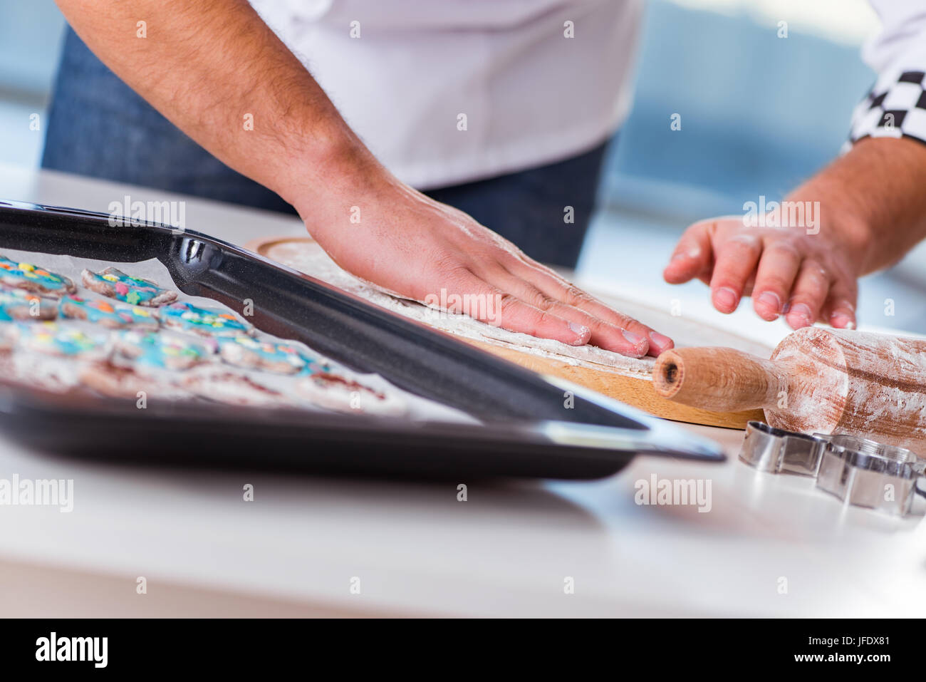 Young man cooking cookies in kitchen Stock Photo - Alamy