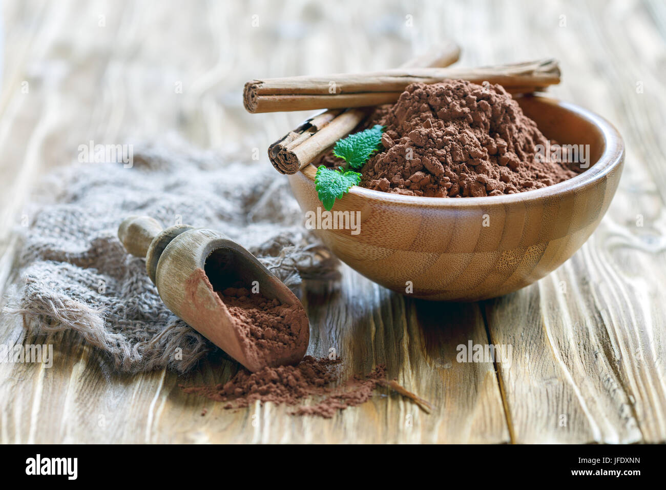 Bowl and a wooden scoop with cocoa powder Stock Photo - Alamy