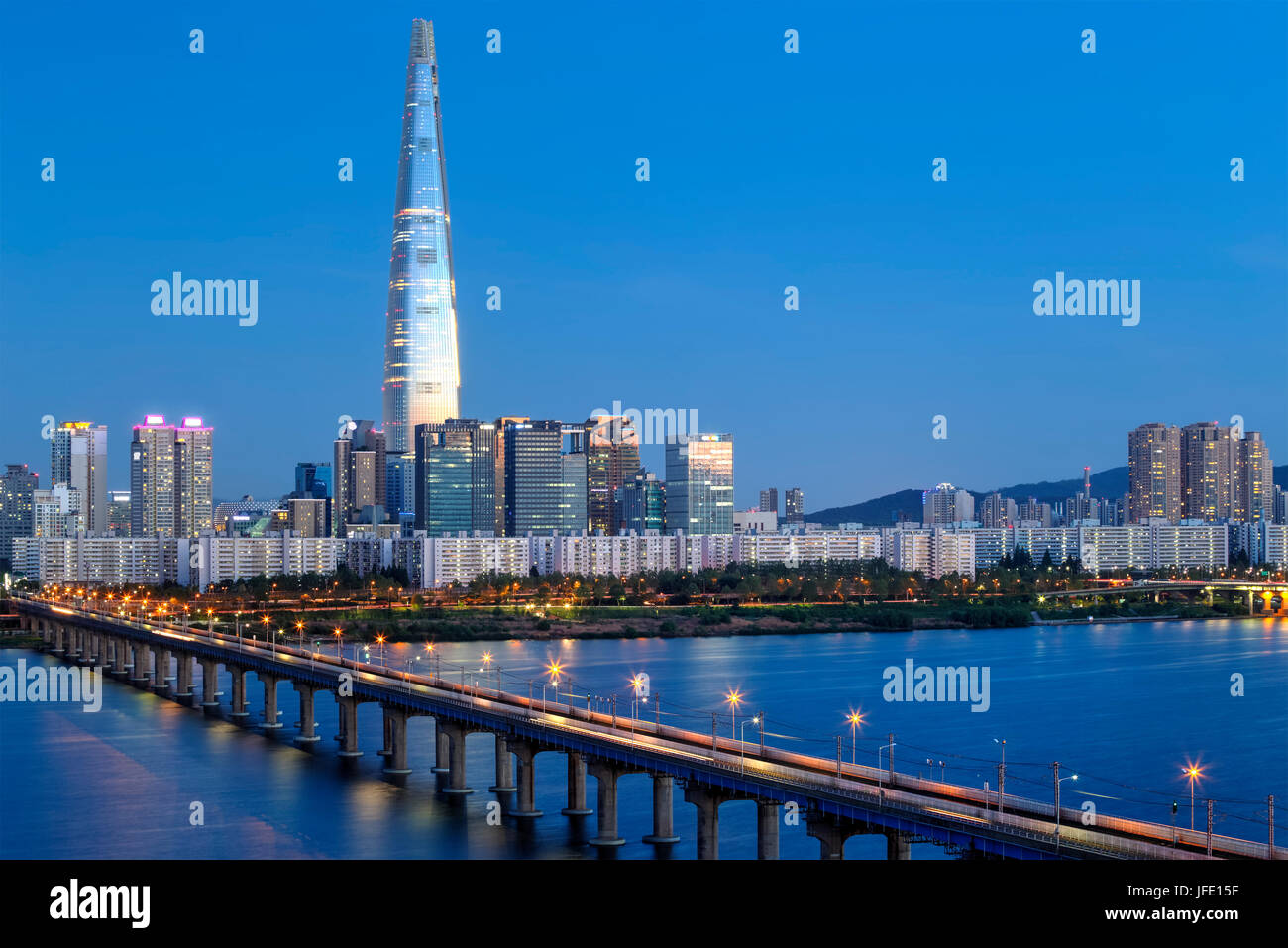 Jamsil bridge over Han River against Seoul Skyline at the blue hour. In ...