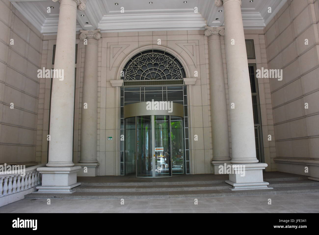 A beautiful entrance to a building with pillars on each side and a ...