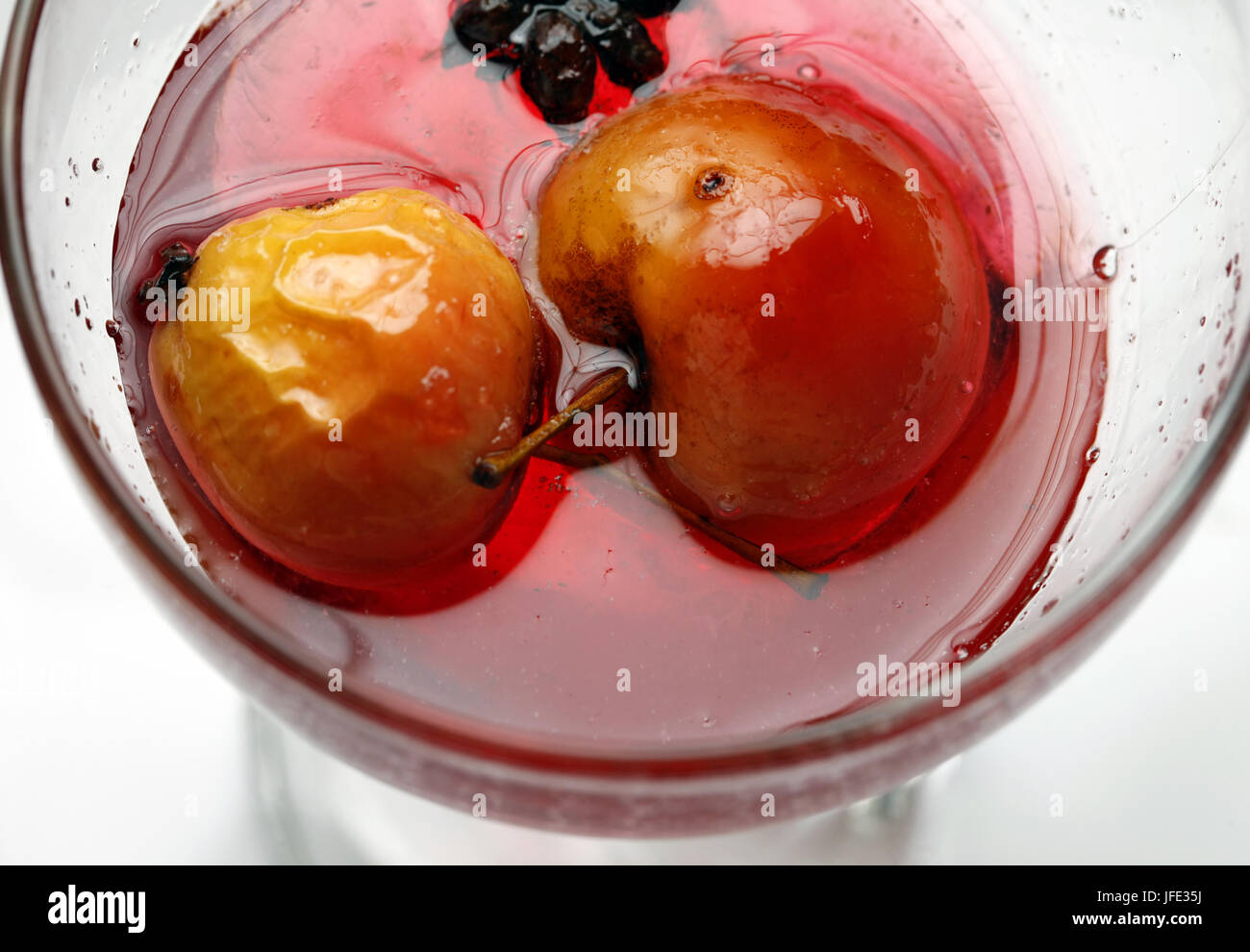Red apple in rose syrup Stock Photo - Alamy