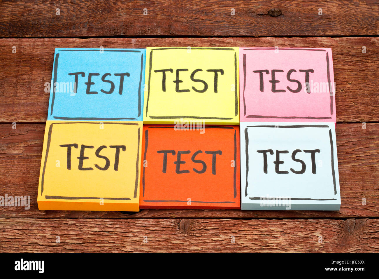 test concept - handwriting in black ink on colorful sticky notes ...