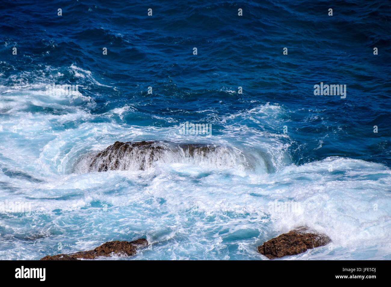 Atlantic waves crashing over rocks in the sea Stock Photo - Alamy
