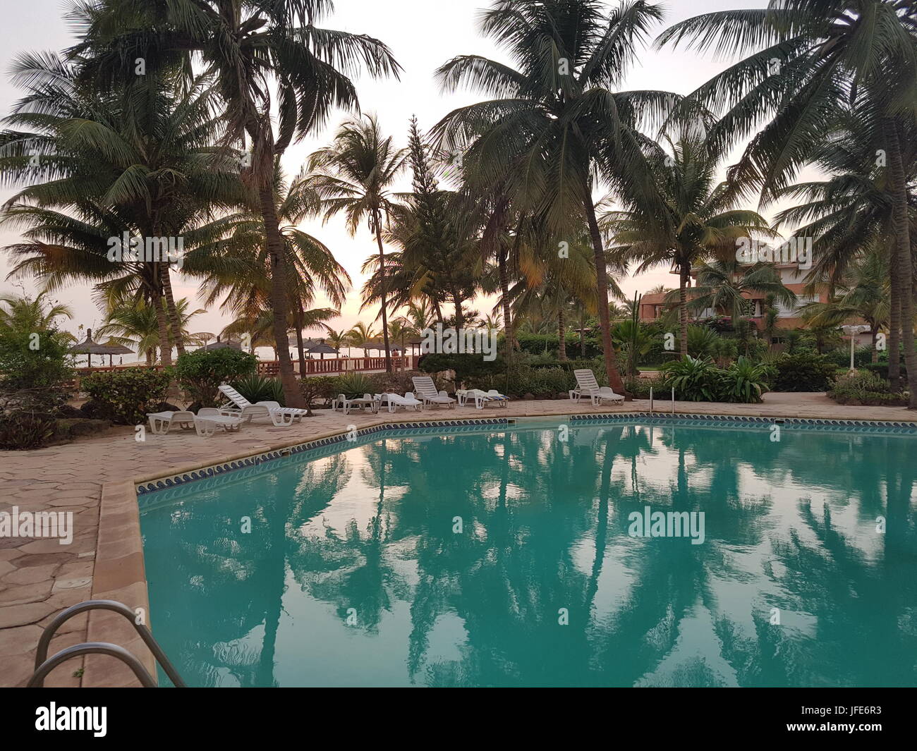 Late night with sunset, swimmingpool at west african beach resort, Saly ...