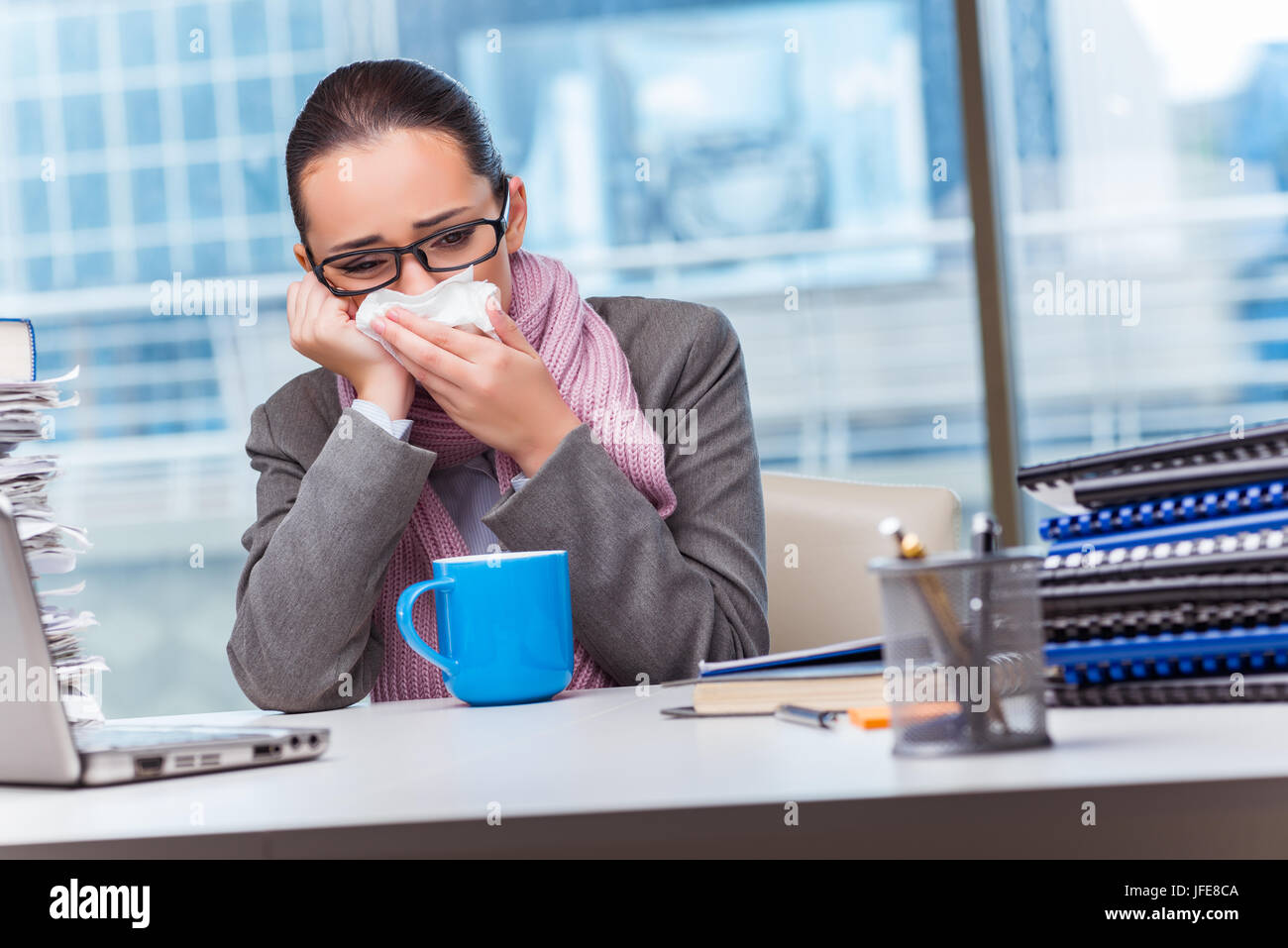 Young businesswoman sick in the office Stock Photo - Alamy