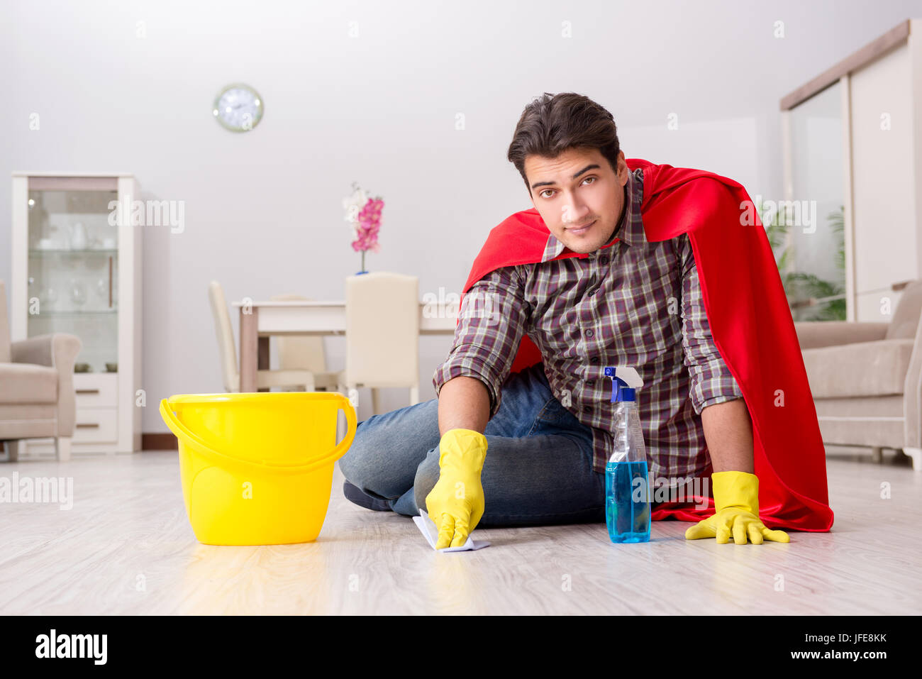 Super hero husband cleaning floor at home Stock Photo - Alamy