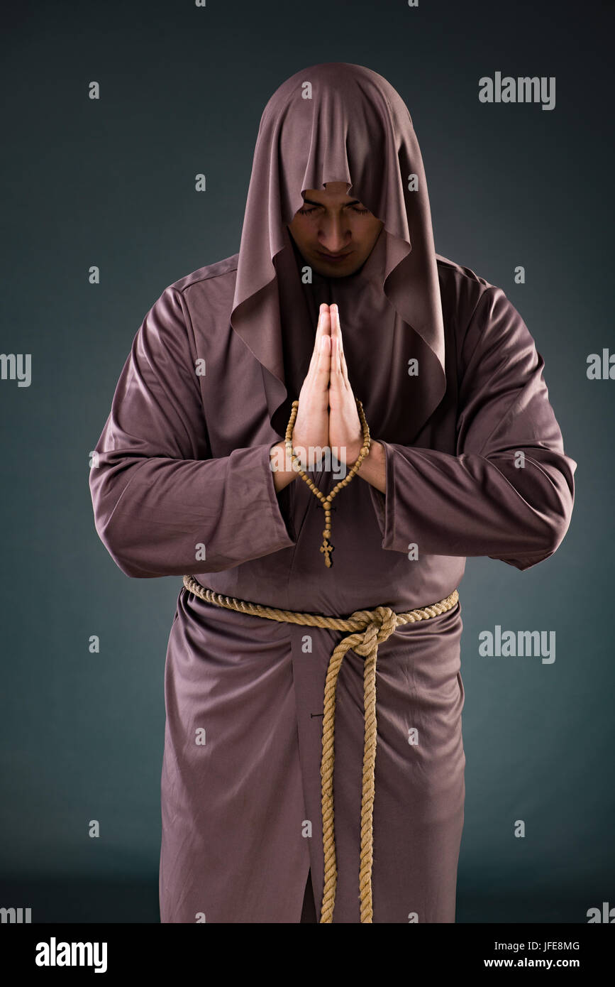 Monk in religious concept on gray background Stock Photo - Alamy