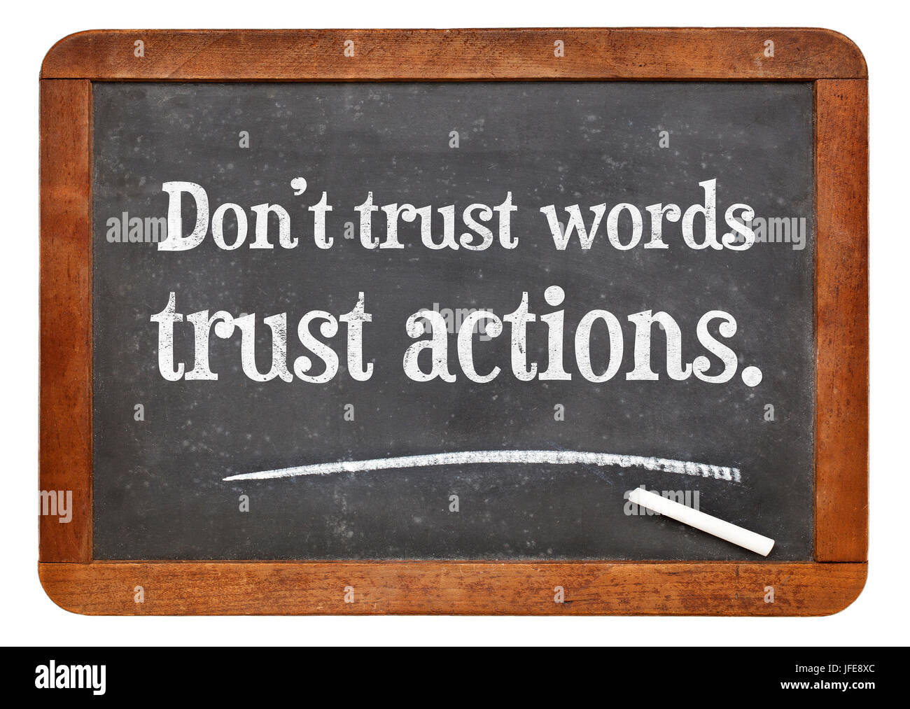 Don't trust words, trust actions - white chalk text on a vintage slate ...