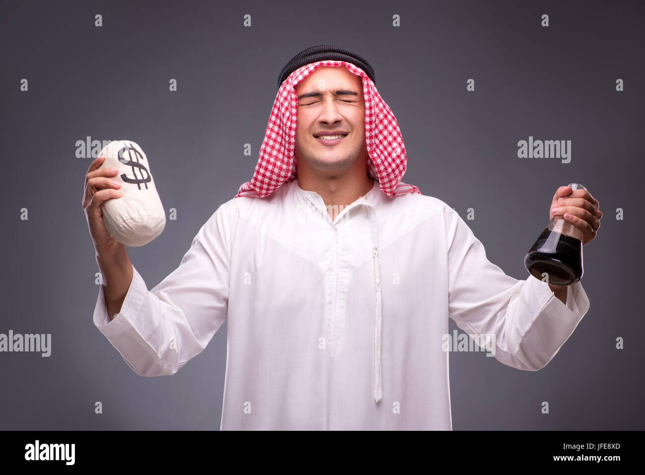 Arab with oil on gray background Stock Photo - Alamy