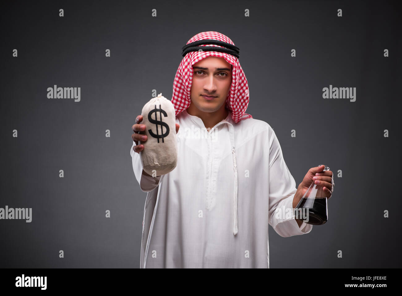Arab with oil on gray background Stock Photo - Alamy