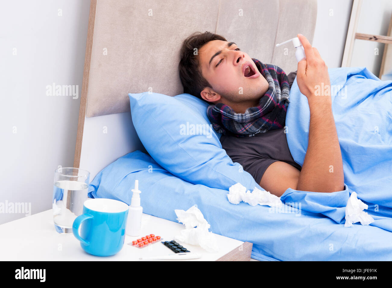 Sick man with flu lying in the bed Stock Photo - Alamy