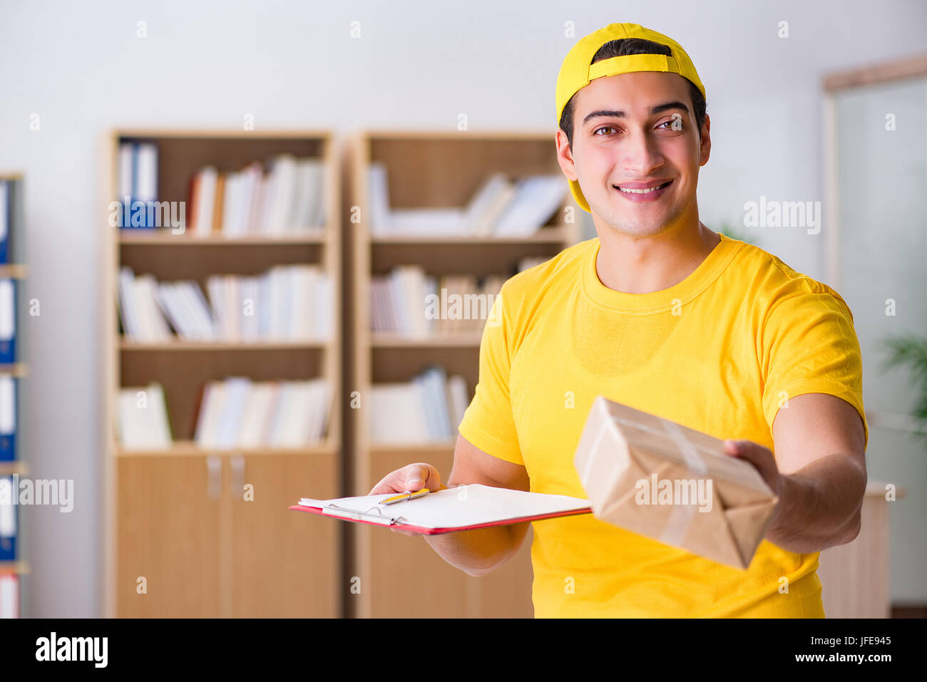 Delivery man delivering parcel box Stock Photo - Alamy