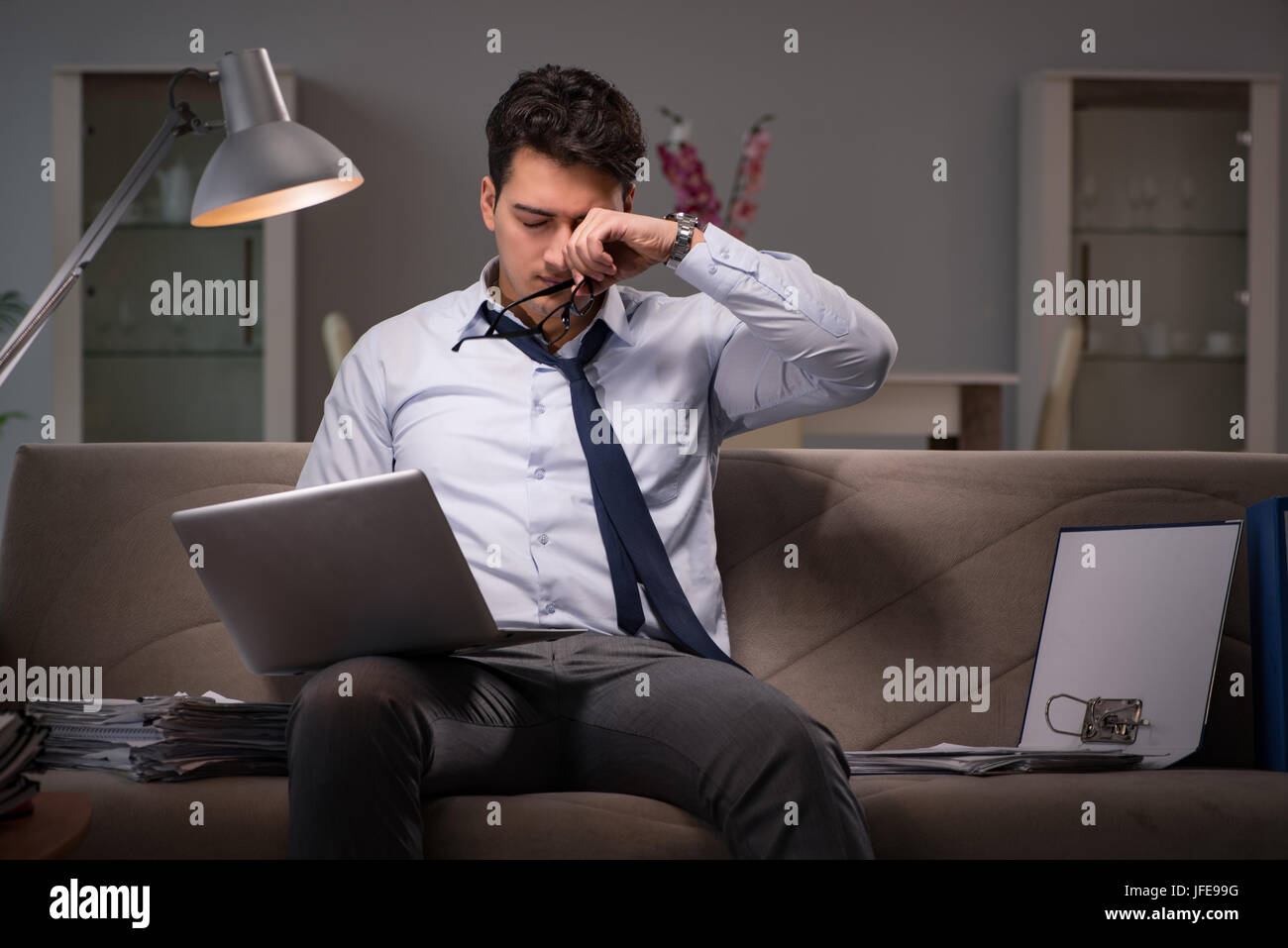 Businessman workaholic working late at home Stock Photo - Alamy
