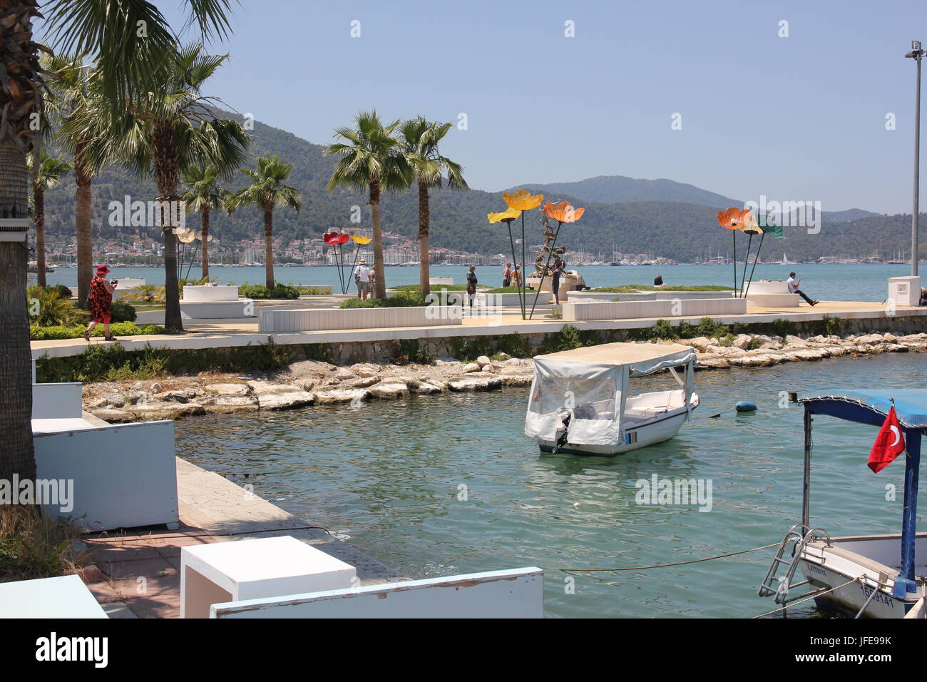 CALIS, TURKEY:English tourists looking at large ornamental flowers ...
