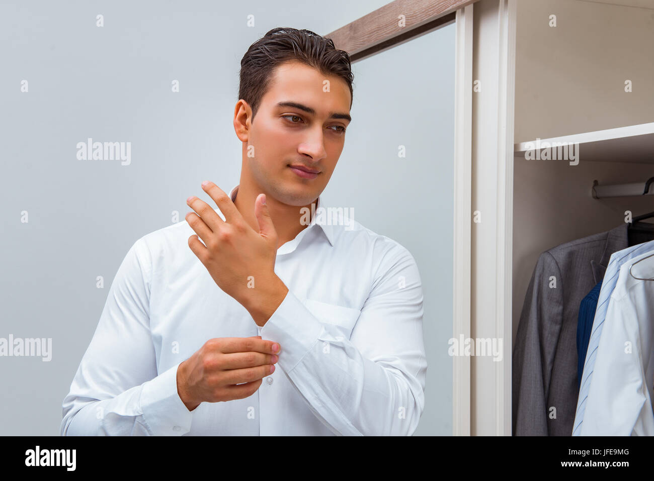 Businessman dressing up for work Stock Photo - Alamy