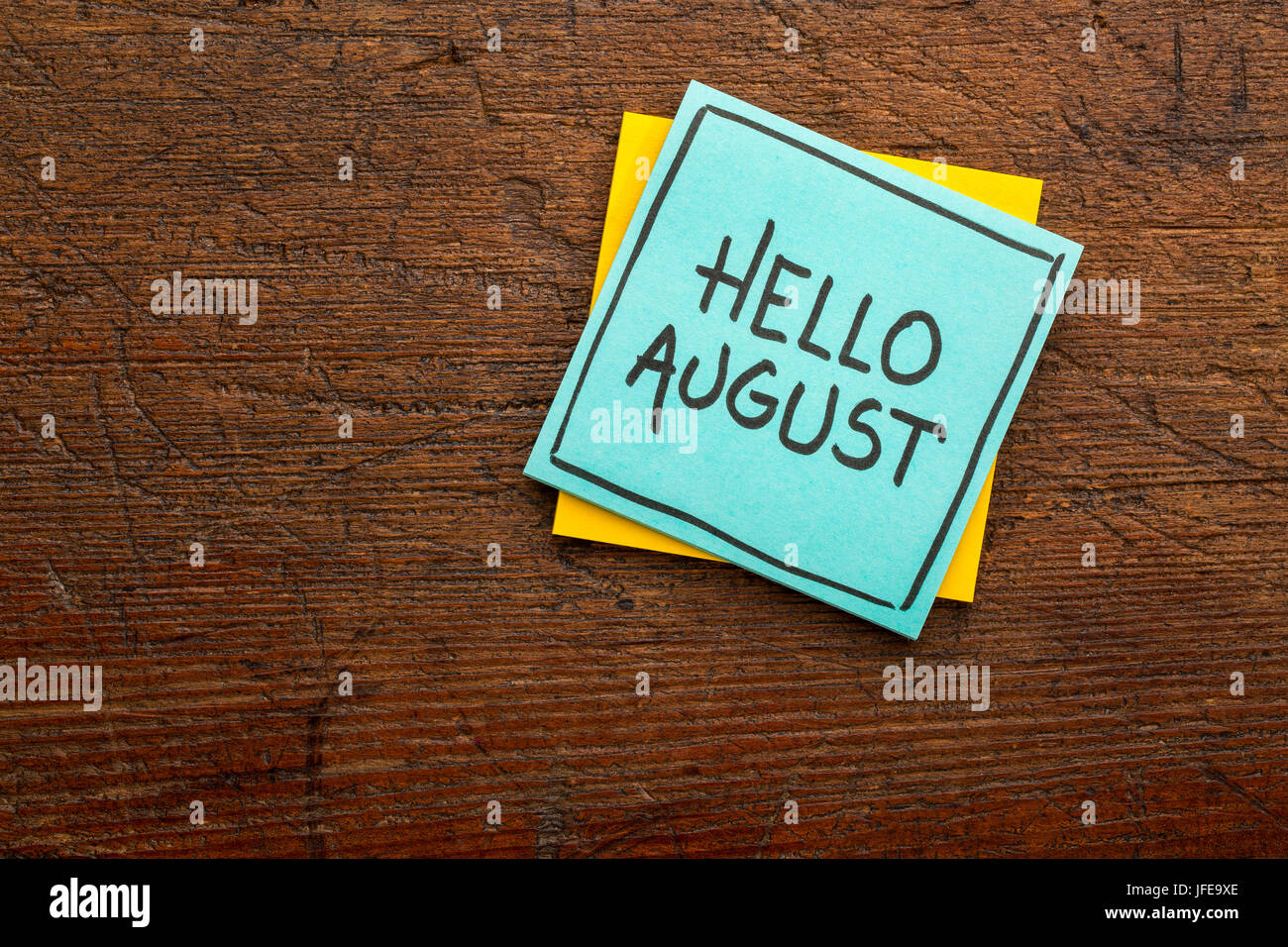 Hello August - handwriting on a sticky note against rustic wood Stock ...