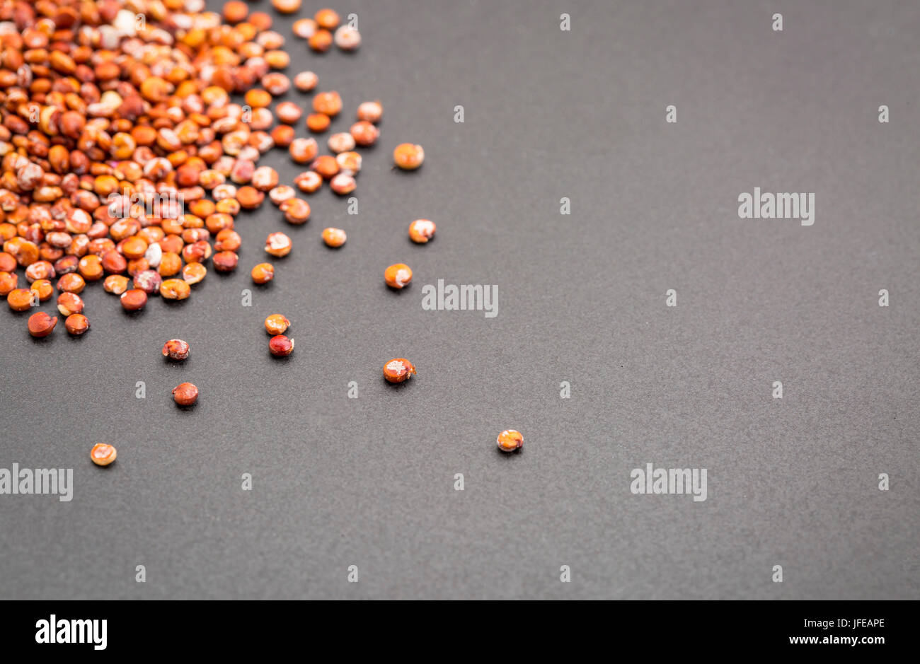 gluten free red quinoa grain - top view of a pile on a dark ceramic ...