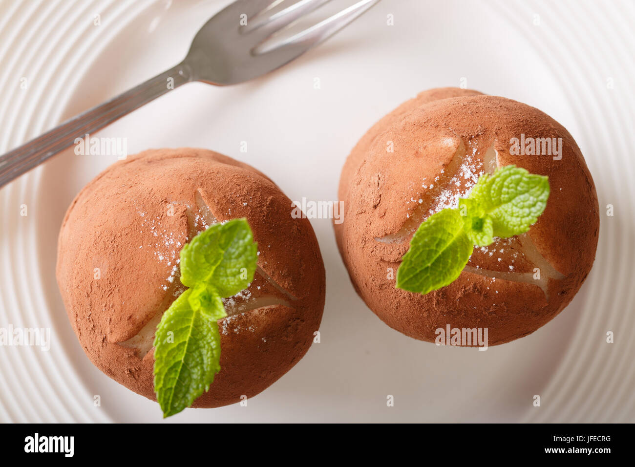 Traditional rum balls cake with mint and cocoa powder close-up on a ...