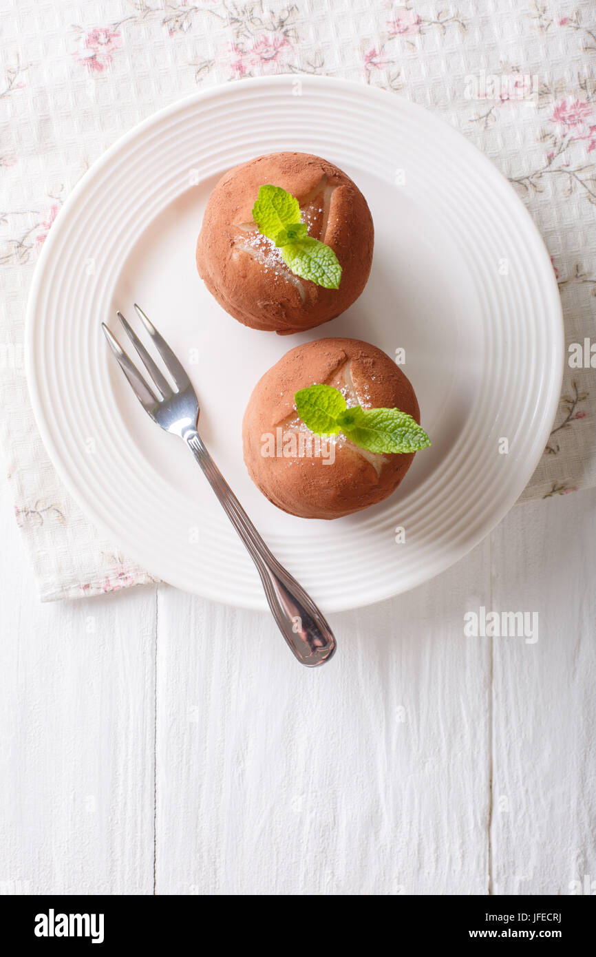 Austrian rum balls cake with mint close-up on a plate. Vertical view ...