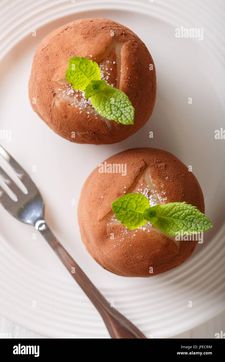 Traditional rum balls cake with mint and cocoa powder close-up on a ...