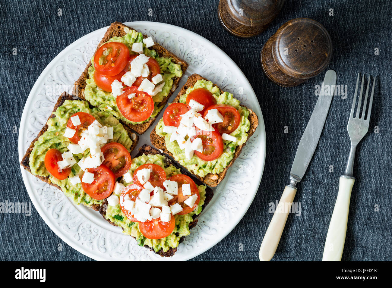 Avocado toast. Healthy toast with avocado mash, cherry tomatoes and ...