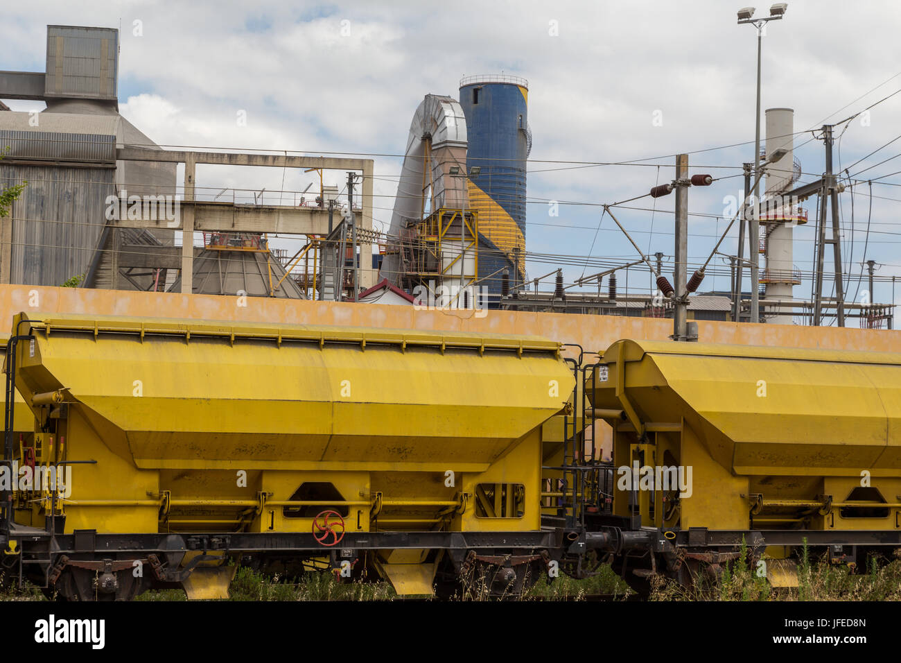 heavy train wagon with industrial building factory Stock Photo - Alamy