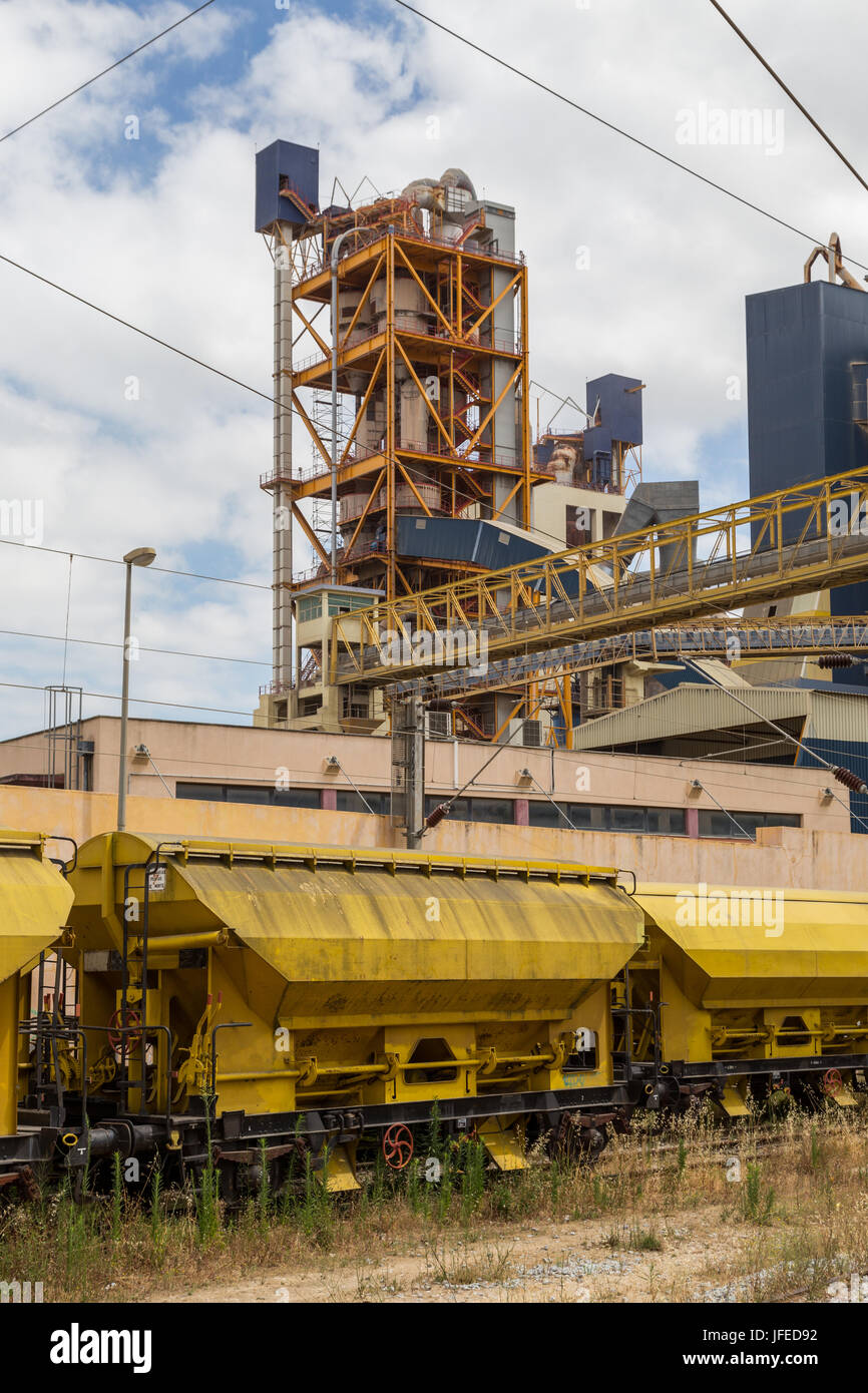 heavy train wagon with industrial building factory Stock Photo - Alamy