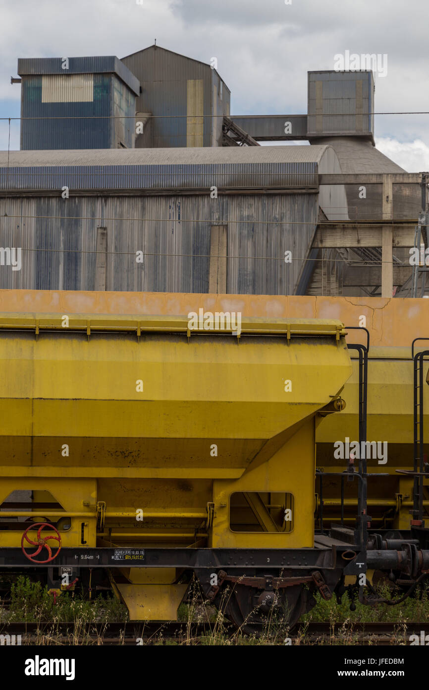 heavy train wagon with industrial building factory Stock Photo - Alamy