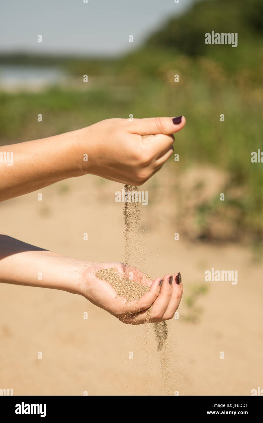 Sand slipping through fingers hand hi-res stock photography and images ...