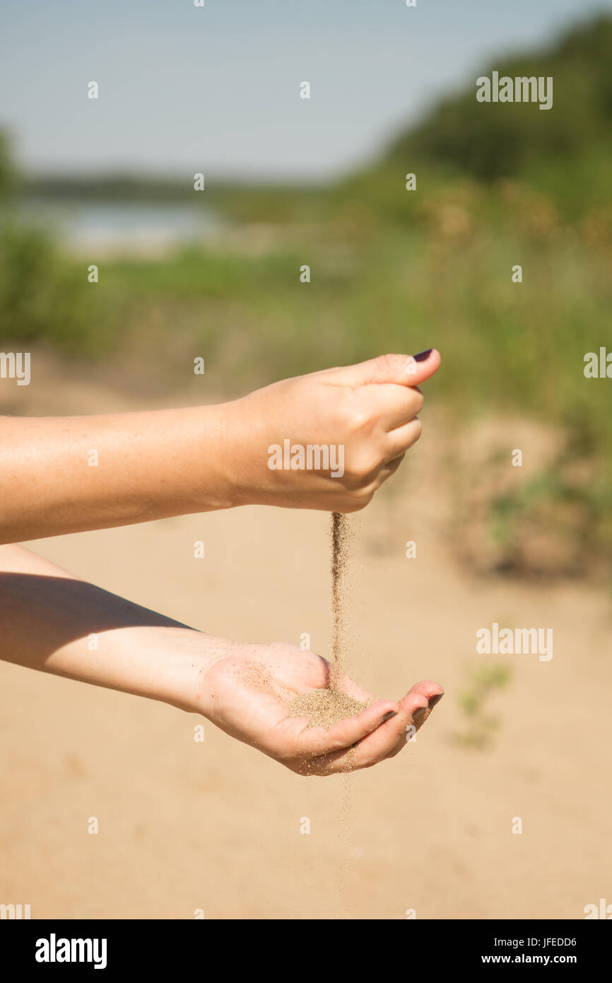 Sand slipping through fingers hand hi-res stock photography and images ...