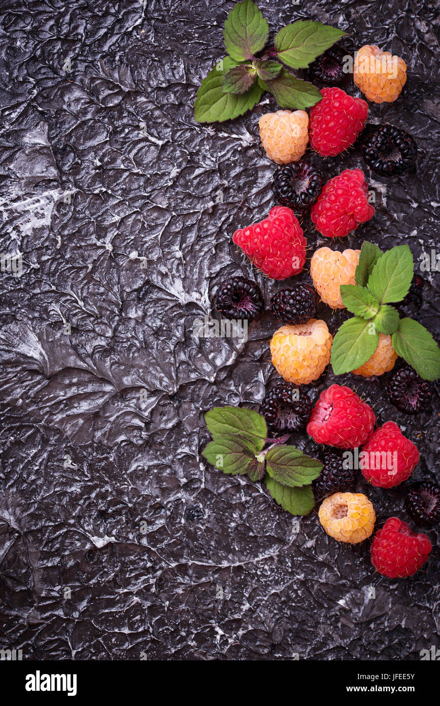 Red, black and yellow raspberry. Selective focus, top view Stock Photo ...