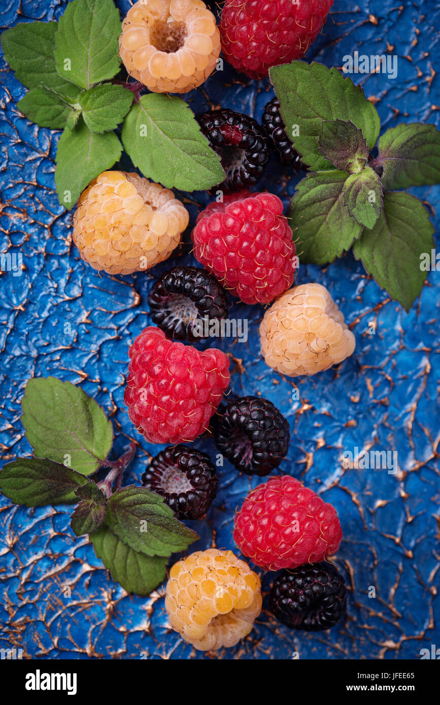 Red, black and yellow raspberry. Selective focus, top view Stock Photo ...