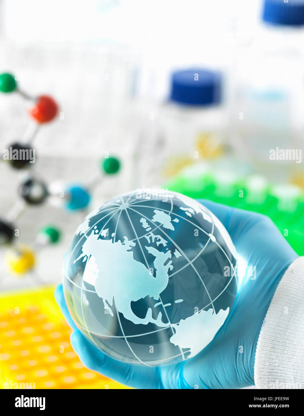 Global research, conceptual image. Scientist holding a globe with a ...