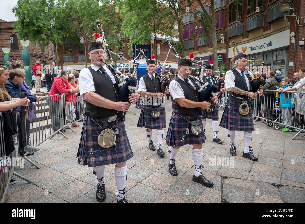 Pipers in the Oldham Scottish Pipe Band marching through the town ...