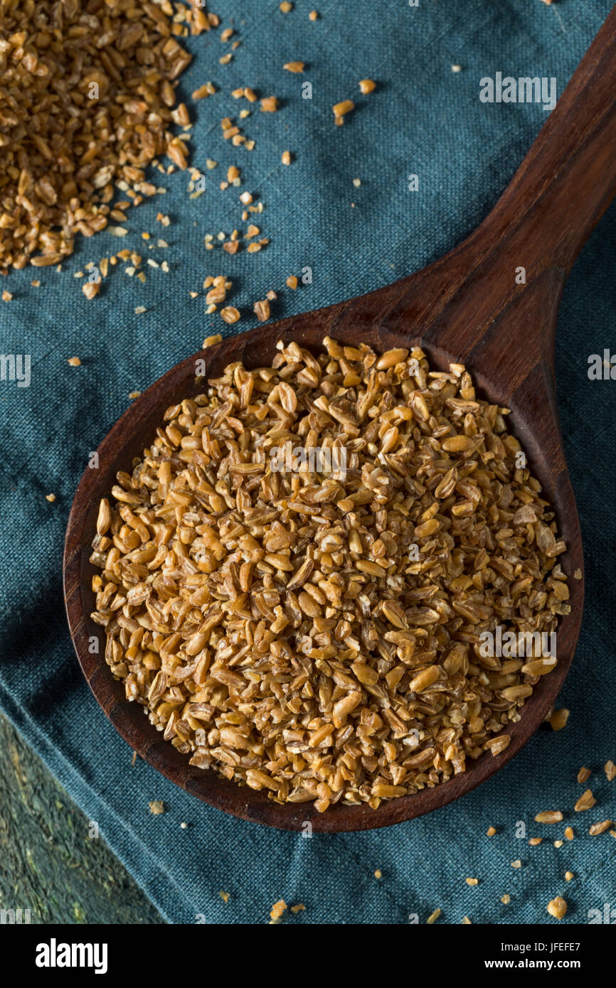 Raw Organic Brown Bulgar Wheat in a Spoon Stock Photo - Alamy