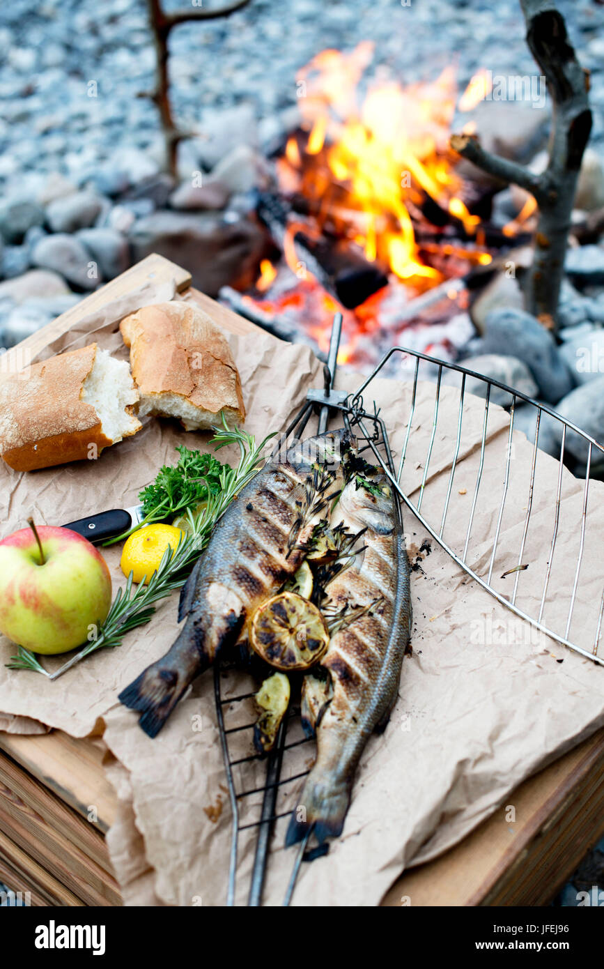 Finished grilled branzino, campfire, have a barbecue Stock Photo - Alamy