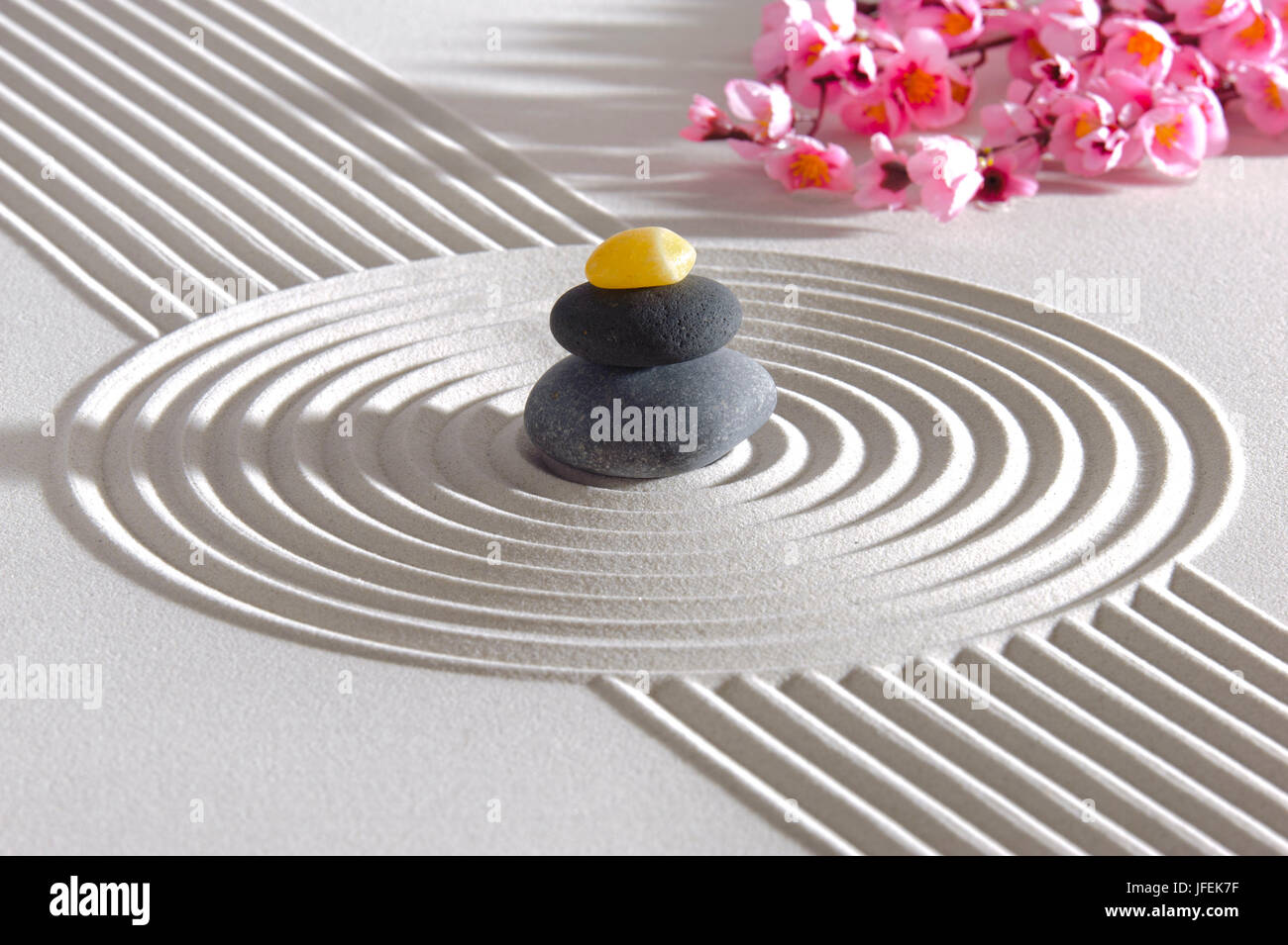 Japanese ZEN garden with stone tower and blossoms in Sand Stock Photo ...